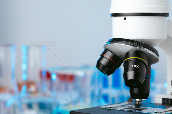 Scientific laboratory with microscope and test tubes with samples ...