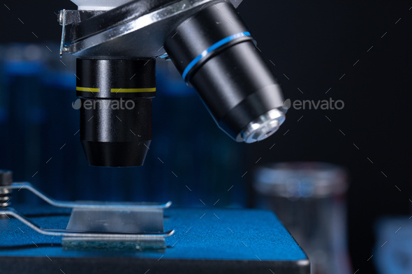 Microscope with lenses close up against dark background Stock Photo by ...