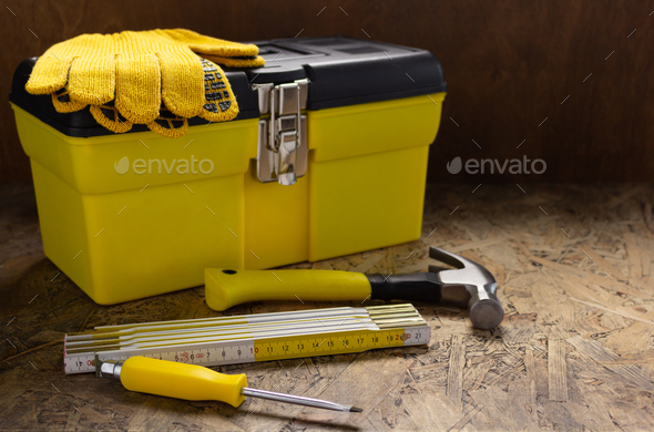 Construction tools and toolbox on wooden tablel background texture ...