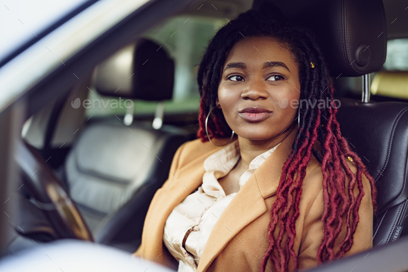 Portrait of positive african american lady inside the car Stock Photo ...