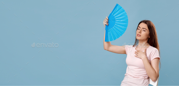 Sweaty beautiful lady with closed eyes cooling with hand fan Stock ...