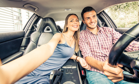 Couple taking a selfie into a sport car while driving Stock Photo by ...