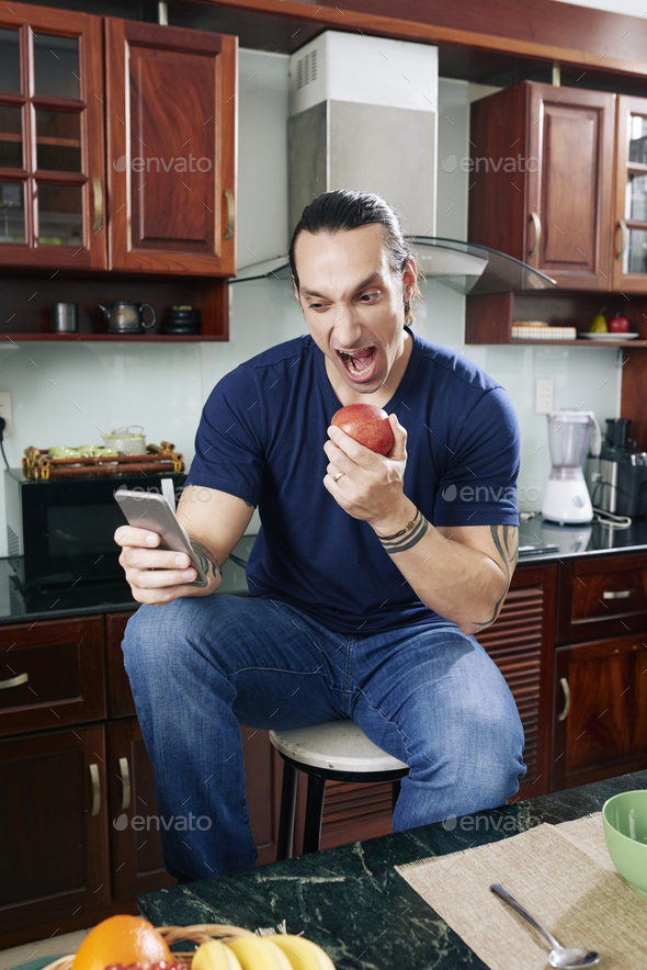 Angry Man Eating Apple Stock Photo by DragonImages | PhotoDune