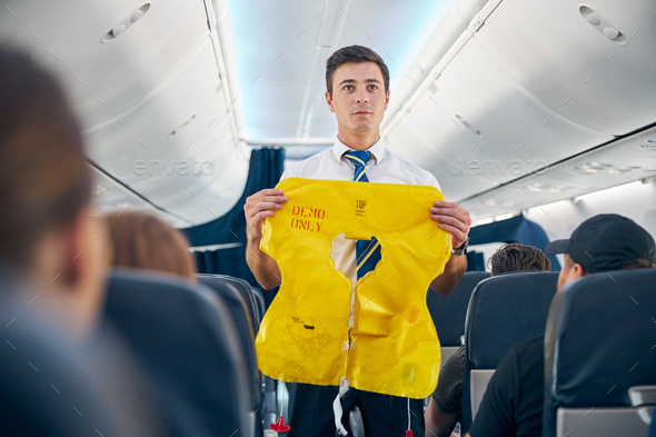Steward demonstrating airplane rules for safety on board Stock Photo by ...