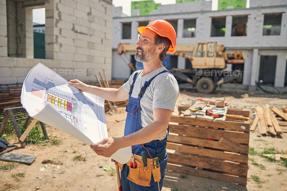 Man with a house plan looking ahead Stock Photo by svitlanah | PhotoDune