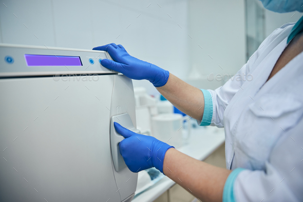 Nurse using modern machine for disinfection equipment after patient ...
