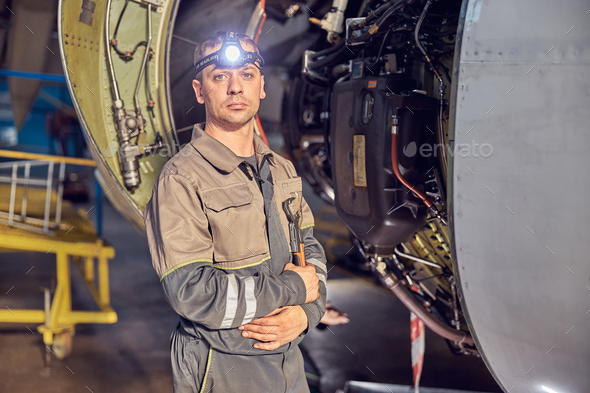 Man with jet turbine in the aviation hangar Stock Photo by svitlanah