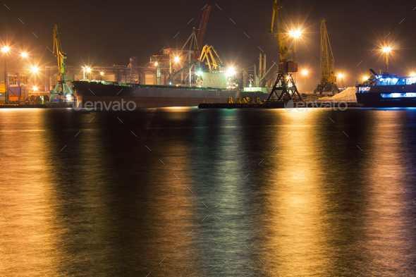 Cargo vessel is moored at container terminal at night Stock Photo by ...