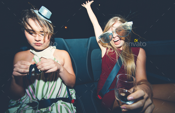 Party girls celebrate in Hollywood drinking champagne on a covertible ...