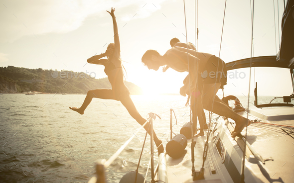 Silhouettes of friends jumping from the boat Stock Photo by ...