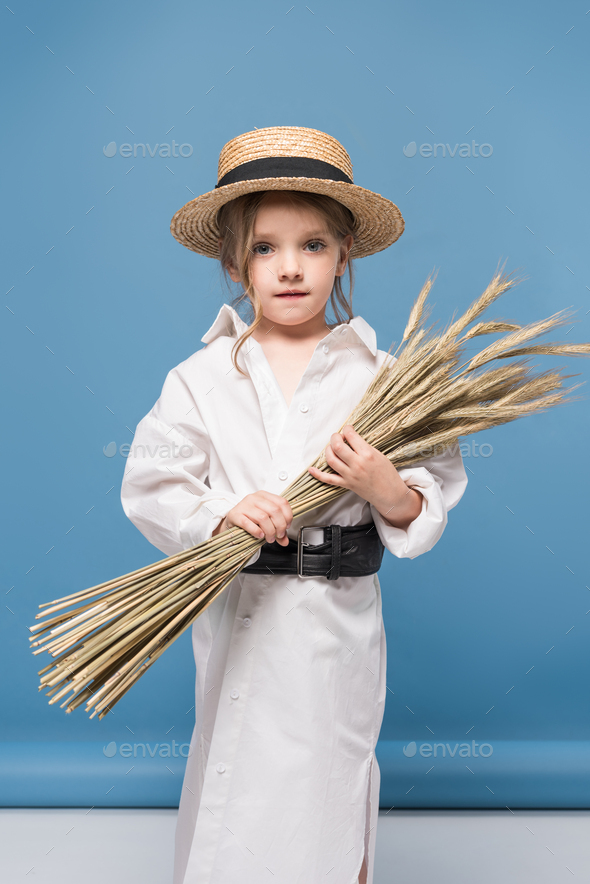 adorable little girl in dress and straw boater holding wheat ears and ...