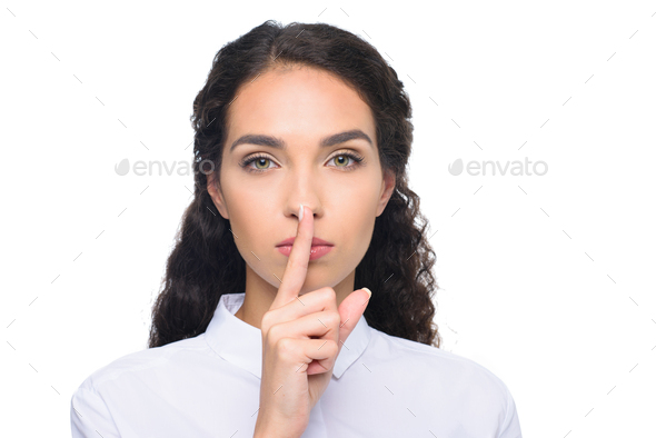 serious beautiful brunette woman showing silence symbol, isolated on ...