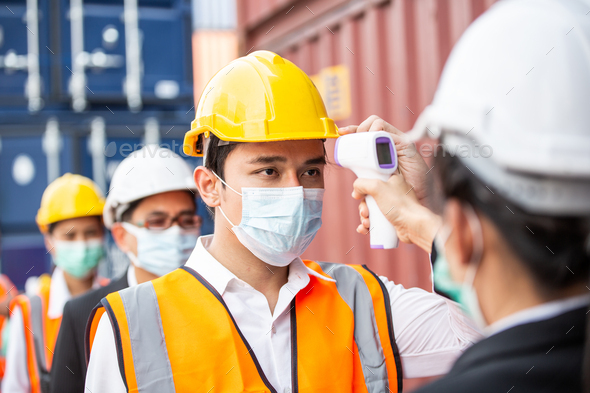 Female worker scanning fever temperature with digital thermometer Stock ...
