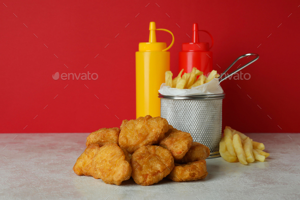 Concept of fast food against red background Stock Photo by AtlasComposer