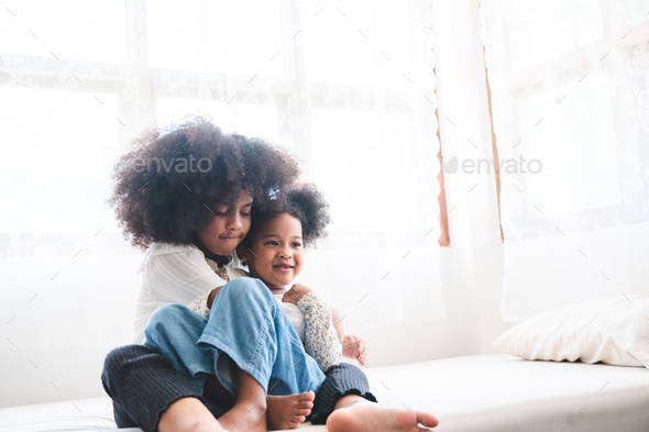 African sibling cuddle each other, lovely family concept, kid playing ...