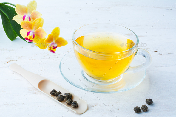 Cup of tea and green tea balls Stock Photo by TasiPas | PhotoDune