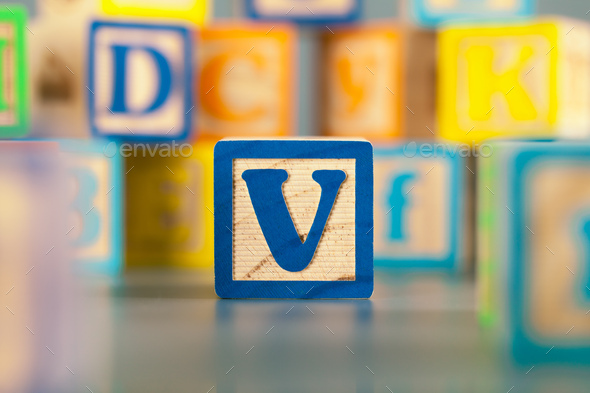 Photograph of colorful Wooden Block Letter V Stock Photo by FabrikaPhoto