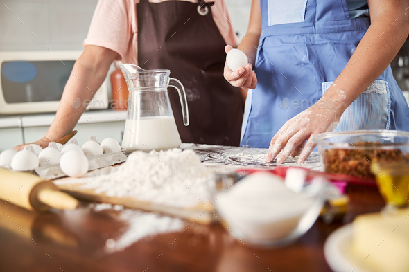 Two people involved in baking process in the kitchen Stock Photo by ...