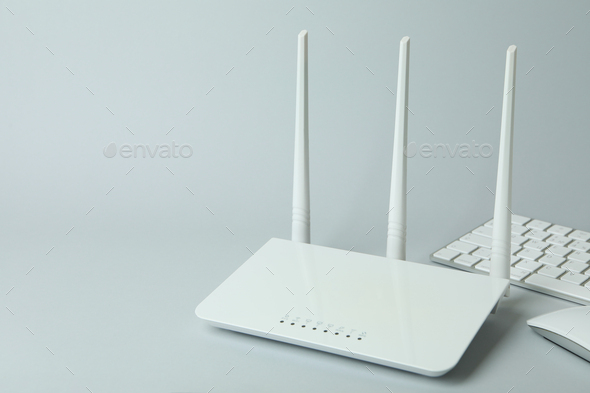 Workplace with Wi - fi router on gray background Stock Photo by ...