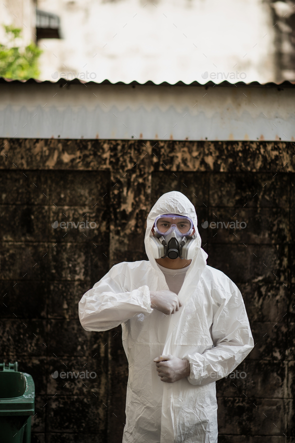 Man in personal protective equipment ppe suit wearing clear glasses and ...