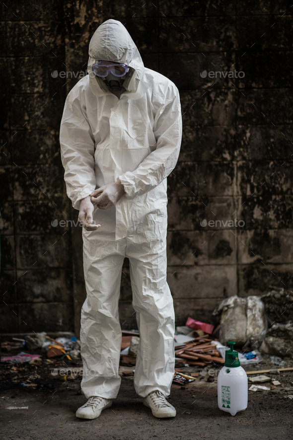 Man in personal protective equipment ppe suit wearing clear glasses and ...