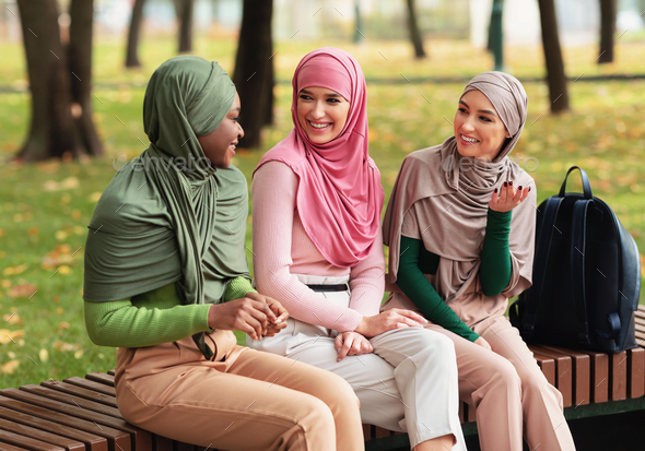 Three Modern Islamic Female Students Spending Time Chatting Outdoors ...