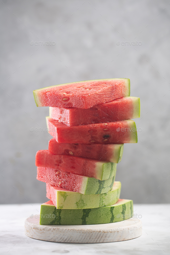 Large red raw watermelon pieces on gray background Stock Photo by Civil