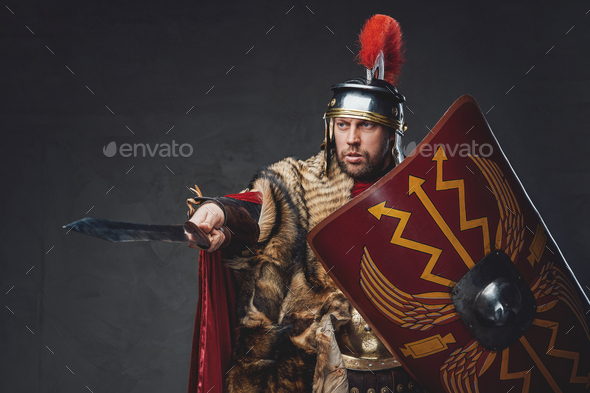Roman general with shield pointing his sword Stock Photo by fxquadro