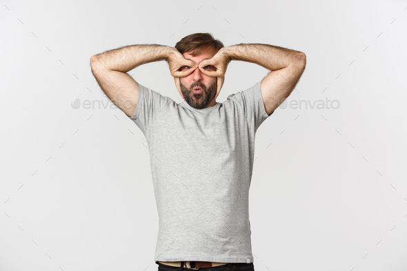 Portrait of funny caucasian guy making faces and mocking someone ...