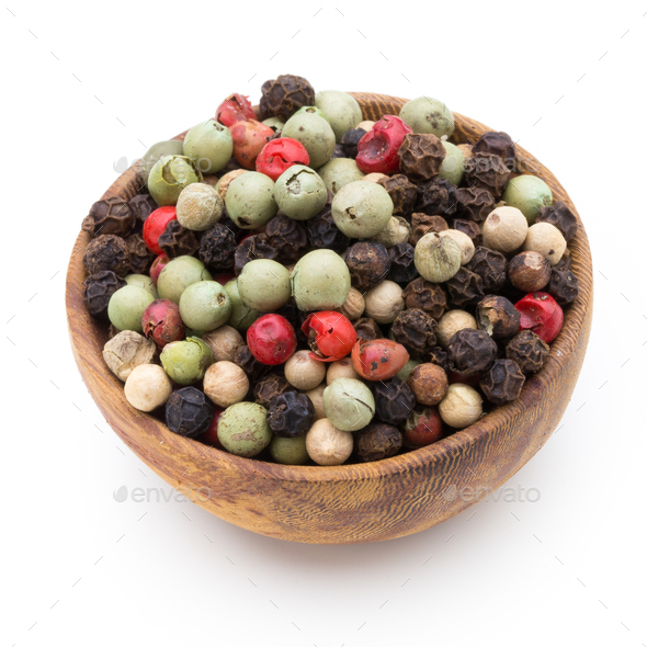 Pepper mix seed on spoon on white background. Stock Photo by GitaKulinica