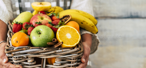 Close up of tasty fresh fruits bucket holded by woman hands and copy ...