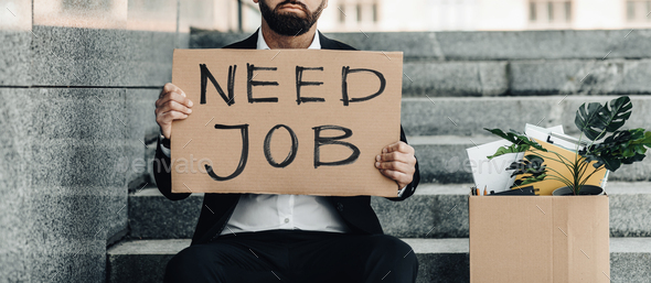 Unemployment concept. Mature businessman sitting on stairs with poster ...