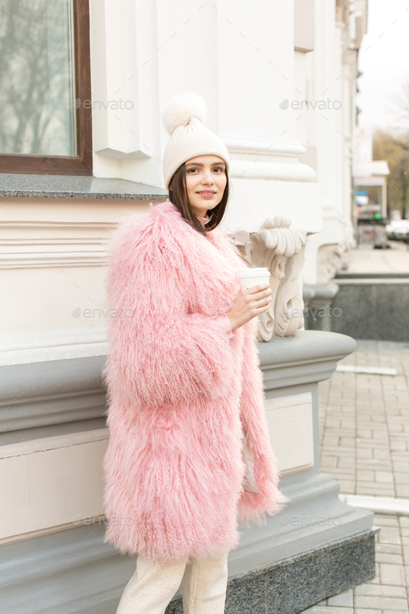 Young smiling women friends posing in pink and blue lama fur coat Stock ...