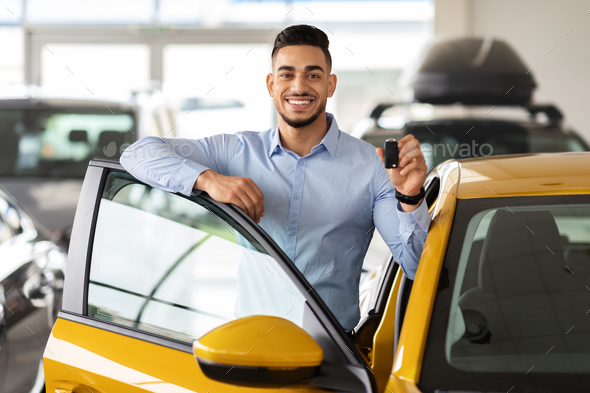 Handsome arab man customer holding key from auto and smiling Stock ...