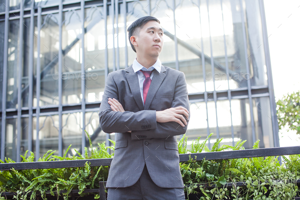 Ambitious Asian Business Person Standing Stock Photo by twinsterphoto
