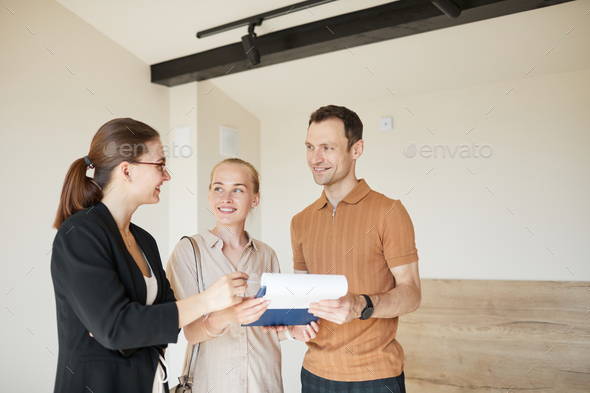 Couple Signing Contract for House Stock Photo by seventyfourimages
