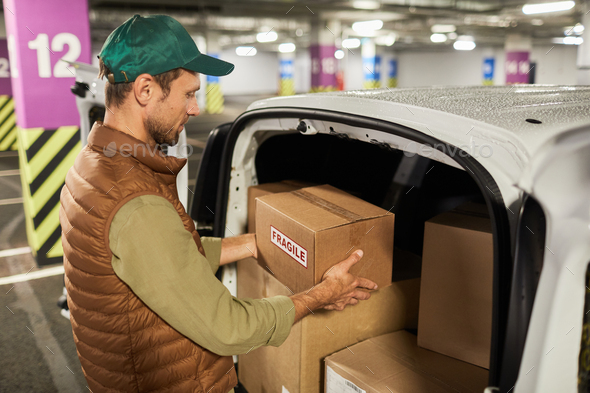 Man Loading Van Side View Stock Photo by seventyfourimages | PhotoDune
