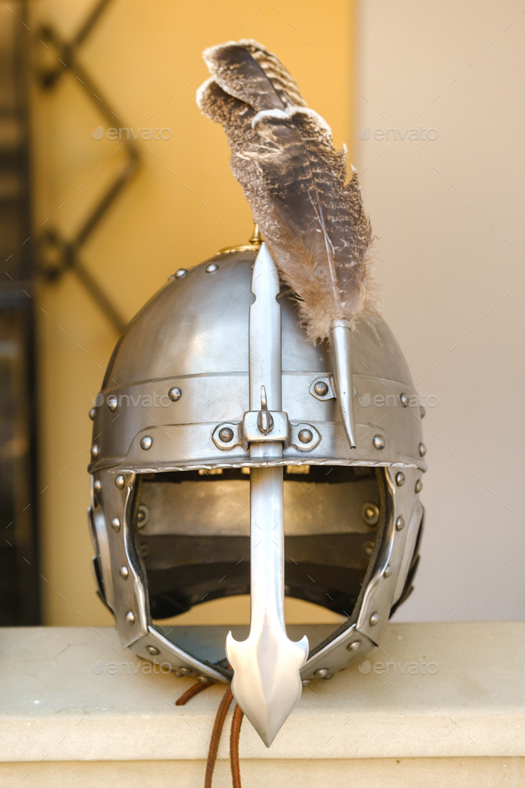 An ancient knight's helmet with a feather .Medieval concept Stock Photo ...