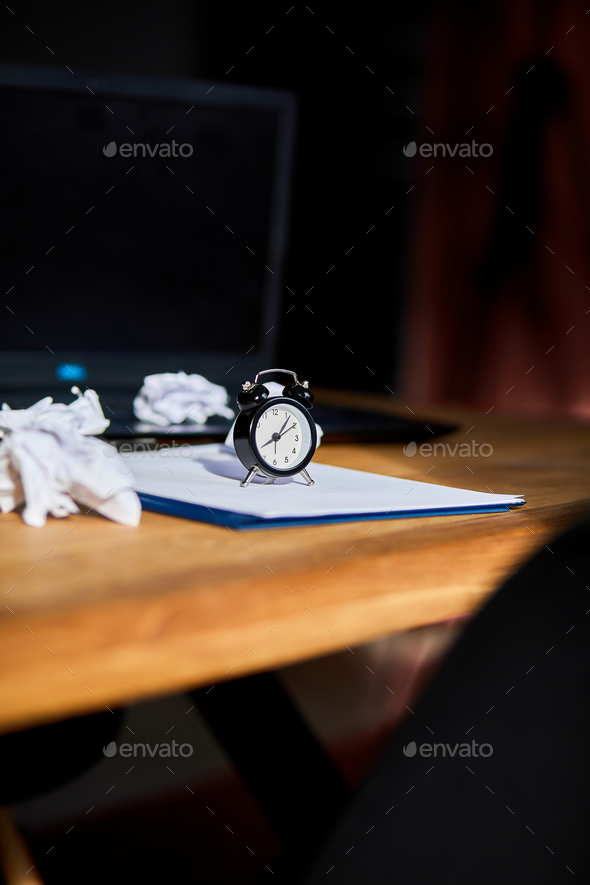 Modern workplace, wooden office desk in hardlight, sunligt with clock ...