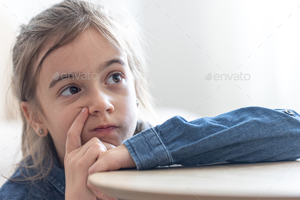 Portrait of a cute little girl, primary school girl. Stock Photo by puhimec
