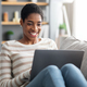 Happy Black Female Browsing Internet On Laptop While Relaxing At Home ...