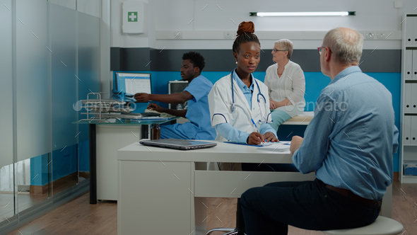 African american doctor examining x ray scan in hand Stock Photo by DC ...