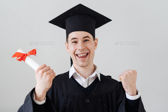 Caucasian young man feeling very excited to receive his bachelors ...