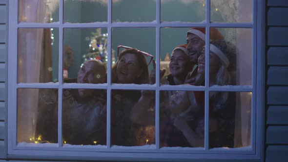 Happy Family Watching Fireworks Through Window, Stock Footage | VideoHive
