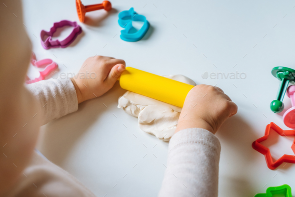 Close View of Child's Hands Playing With Playdough Stock Photo by Kaloriya