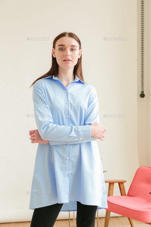 Fashion photo of a stylish female model in a fancy clothes posing over ...