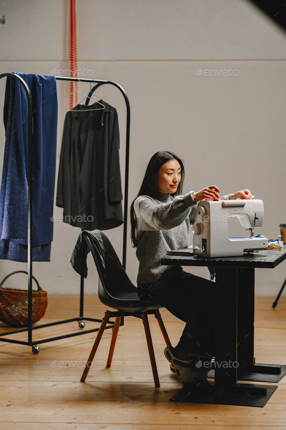 Professional young female tailor working in workshop Stock Photo by ...