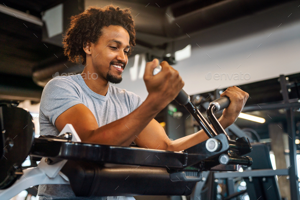 Handsome muscular man working out hard at gym Stock Photo by nd3000