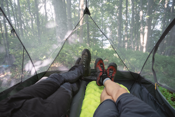 Male legs inside camp tent with summer forest on background Stock Photo ...