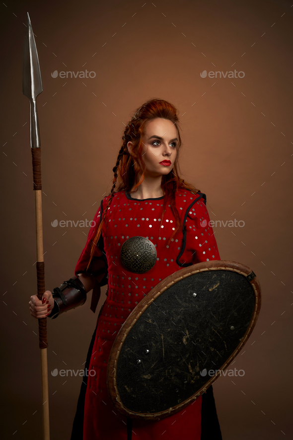 Female warrior keeping spear and shield and posing Stock Photo by ...